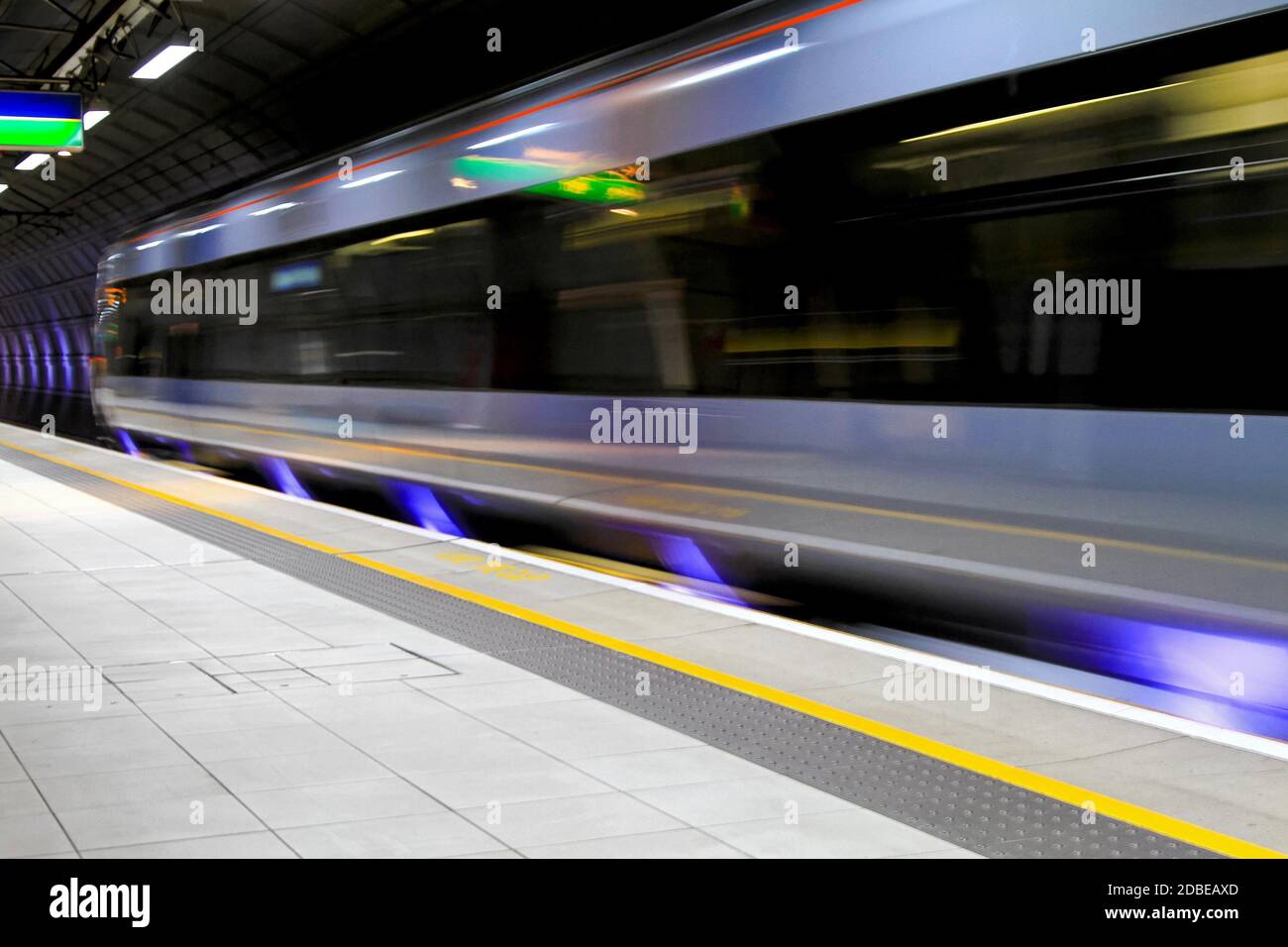 Modern speed train moving through underground station Stock Photo - Alamy