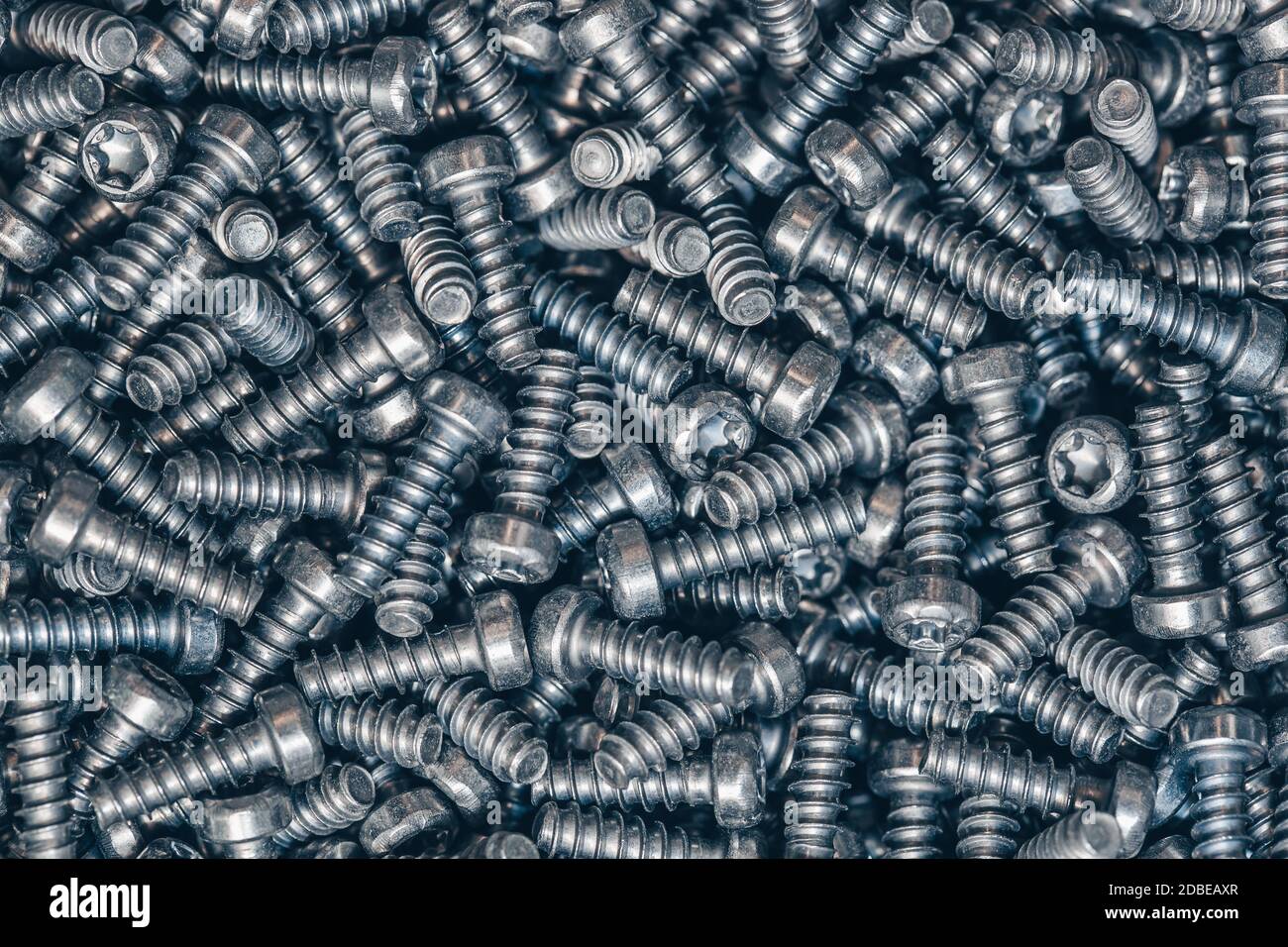 A lot of taping metal or iron screws, screws as a background, wallpaper ...