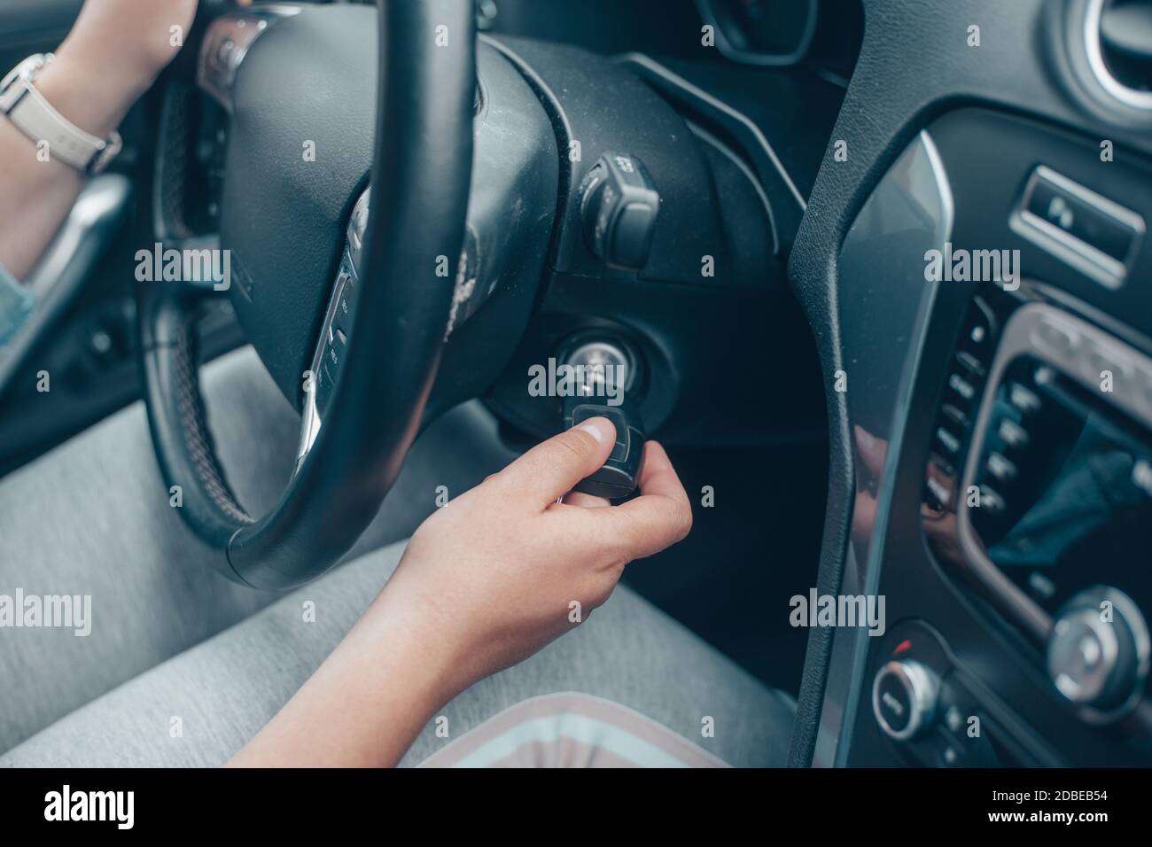 Woman driver starting the car by car key Stock Photo - Alamy