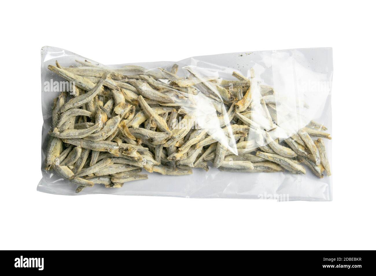 Dried salted anchovies in a transparent package isolated on white ...