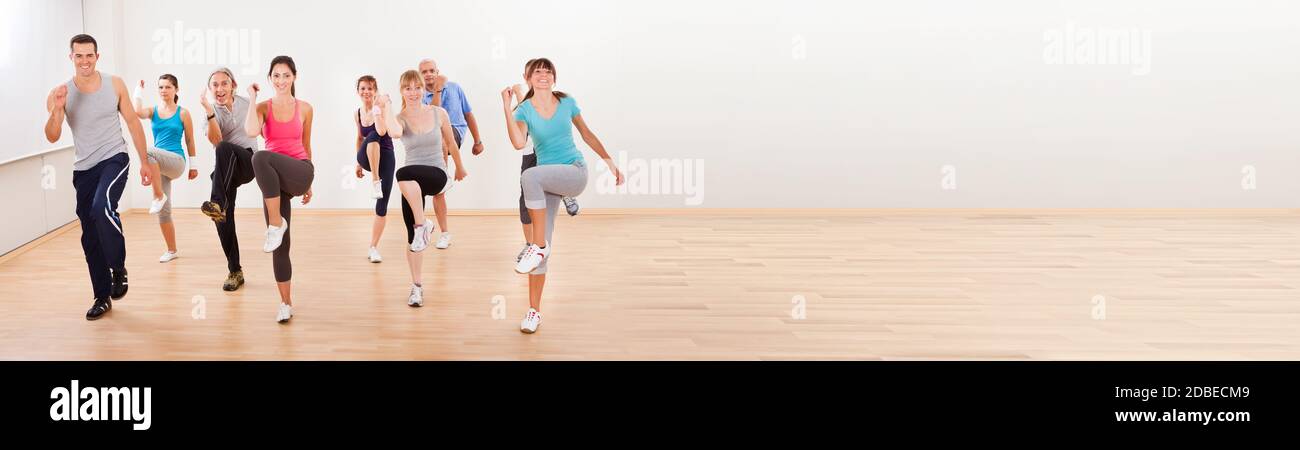 Fit Group Doing Aerobics Exercise At Class In Health Gym Stock Photo ...