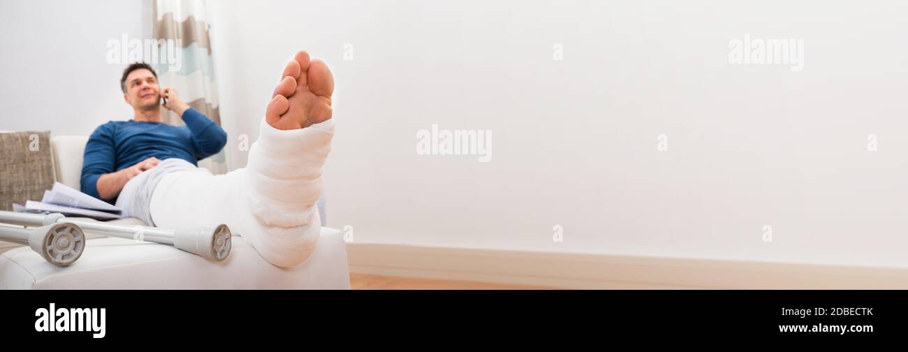 Man With Fracture Cast Recovering From Broken Leg Injury Stock Photo ...