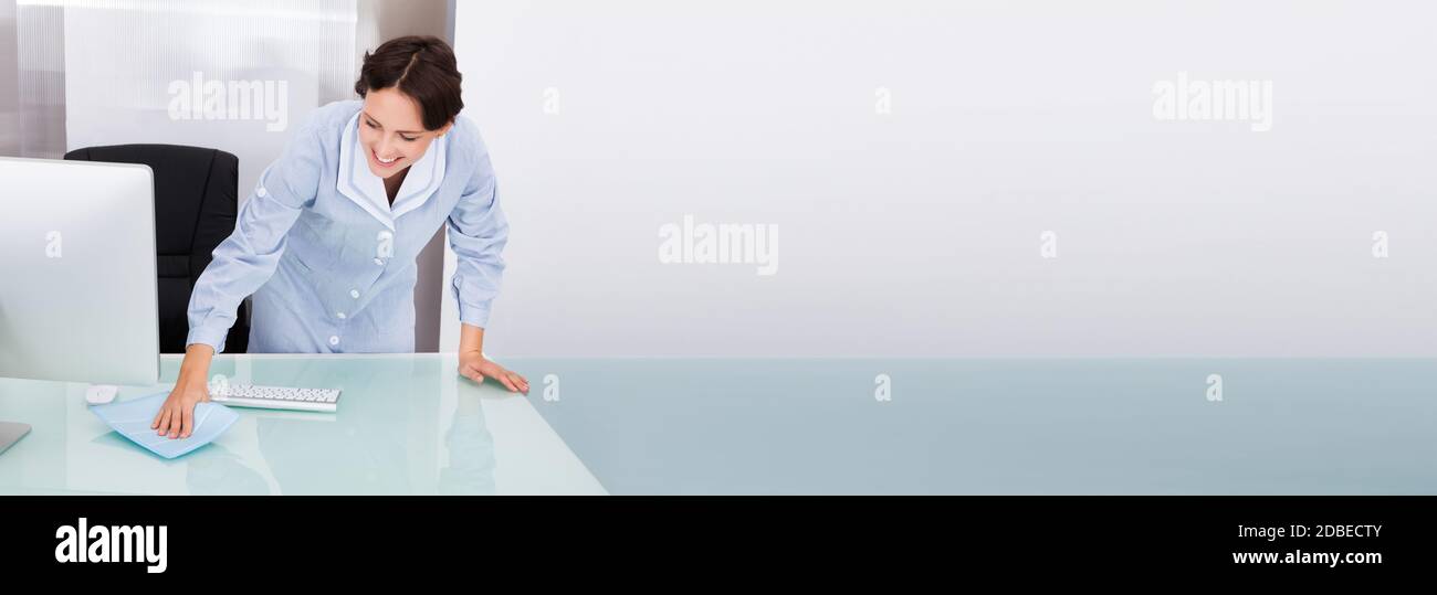 Cleaning Office Computer And Desk. Professional Cleaner Stock Photo - Alamy