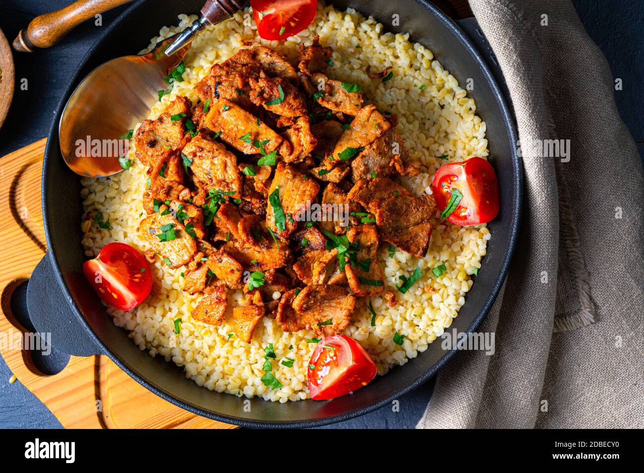 rustic bulgur pans with gratinated gyros and yoghurt Stock Photo - Alamy