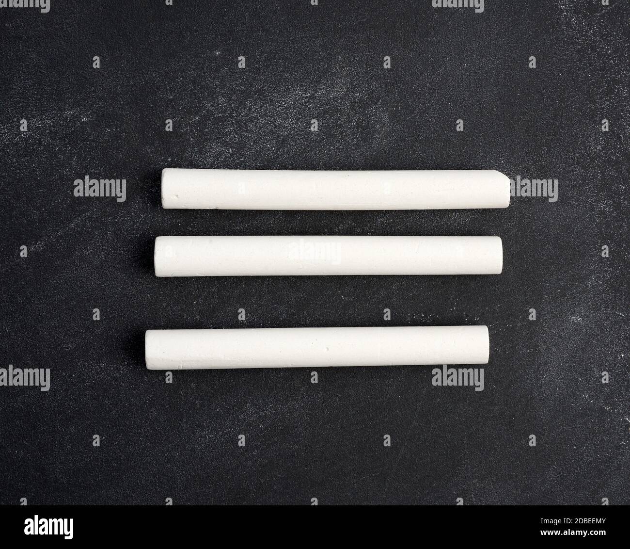 three white chalk on a blackboard, close up Stock Photo - Alamy