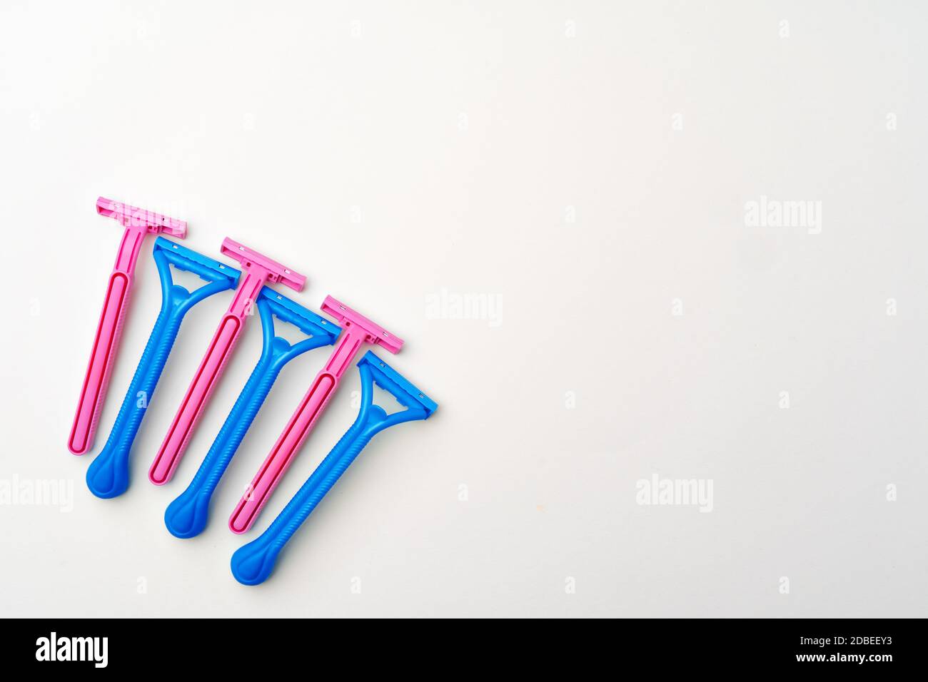 Pink and blue razors on white background Stock Photo - Alamy