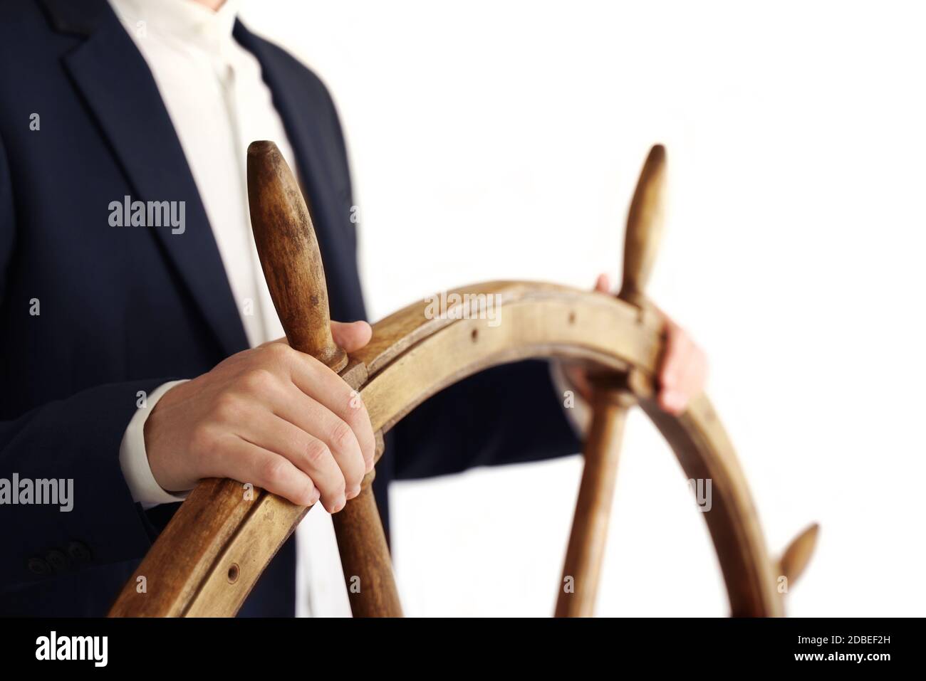 Businessman holding ship rudder Stock Photo - Alamy