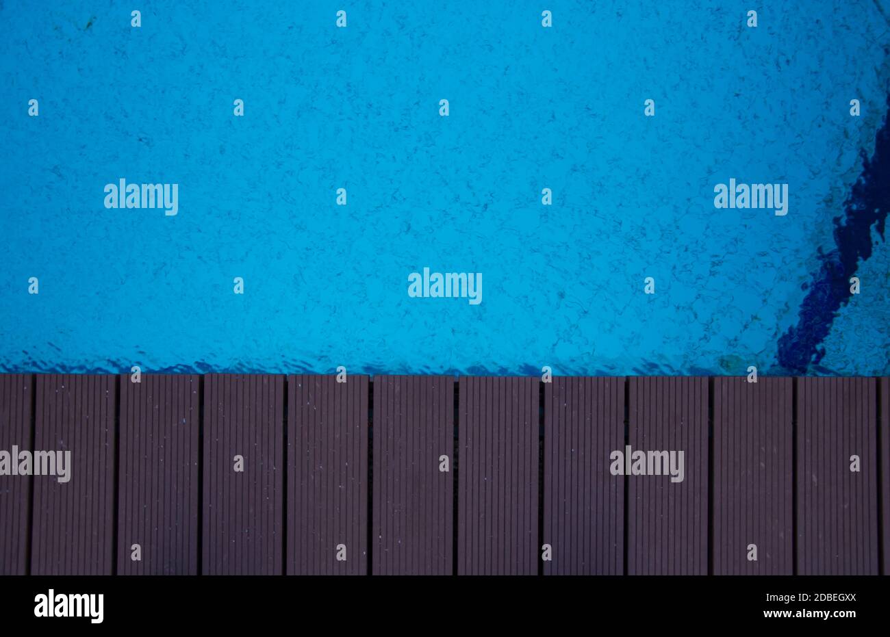 blue swimming pool with teak wood flooring stripes summer vacation ...