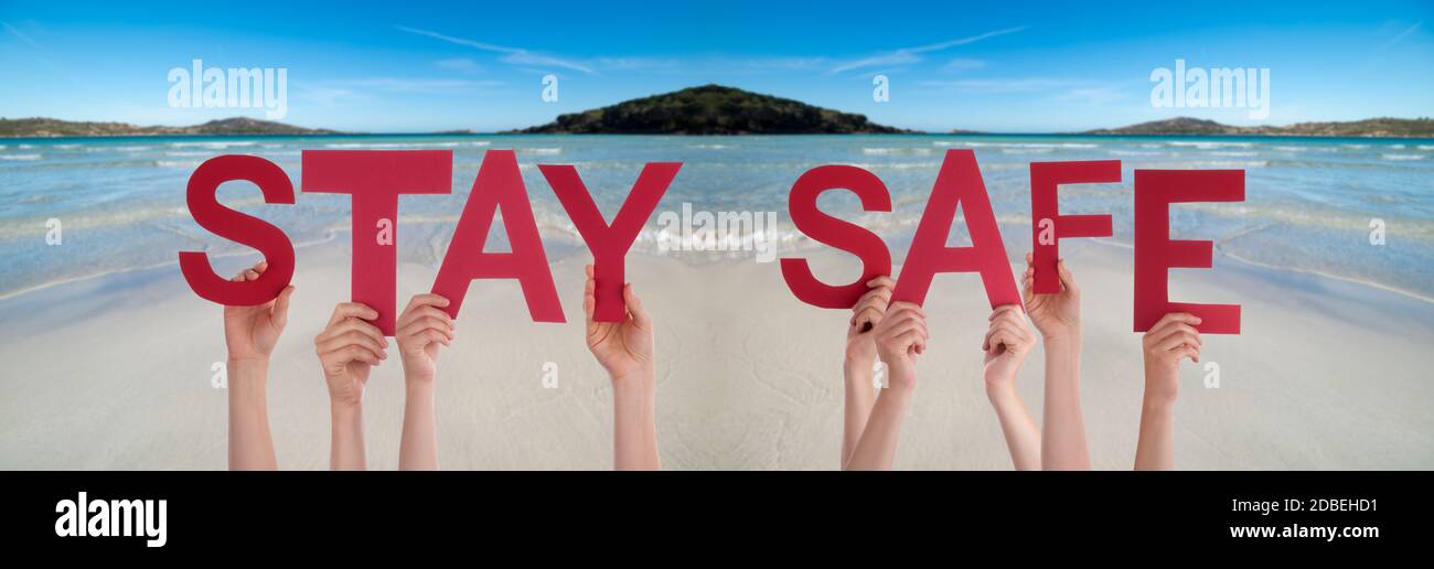 People Hands Holding Colorful English Word Stay Safe. Ocean And Beach ...