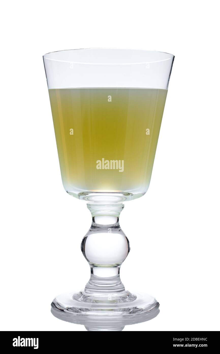 Alcolhol drink jade green absinthe in a glass on white Stock Photo - Alamy