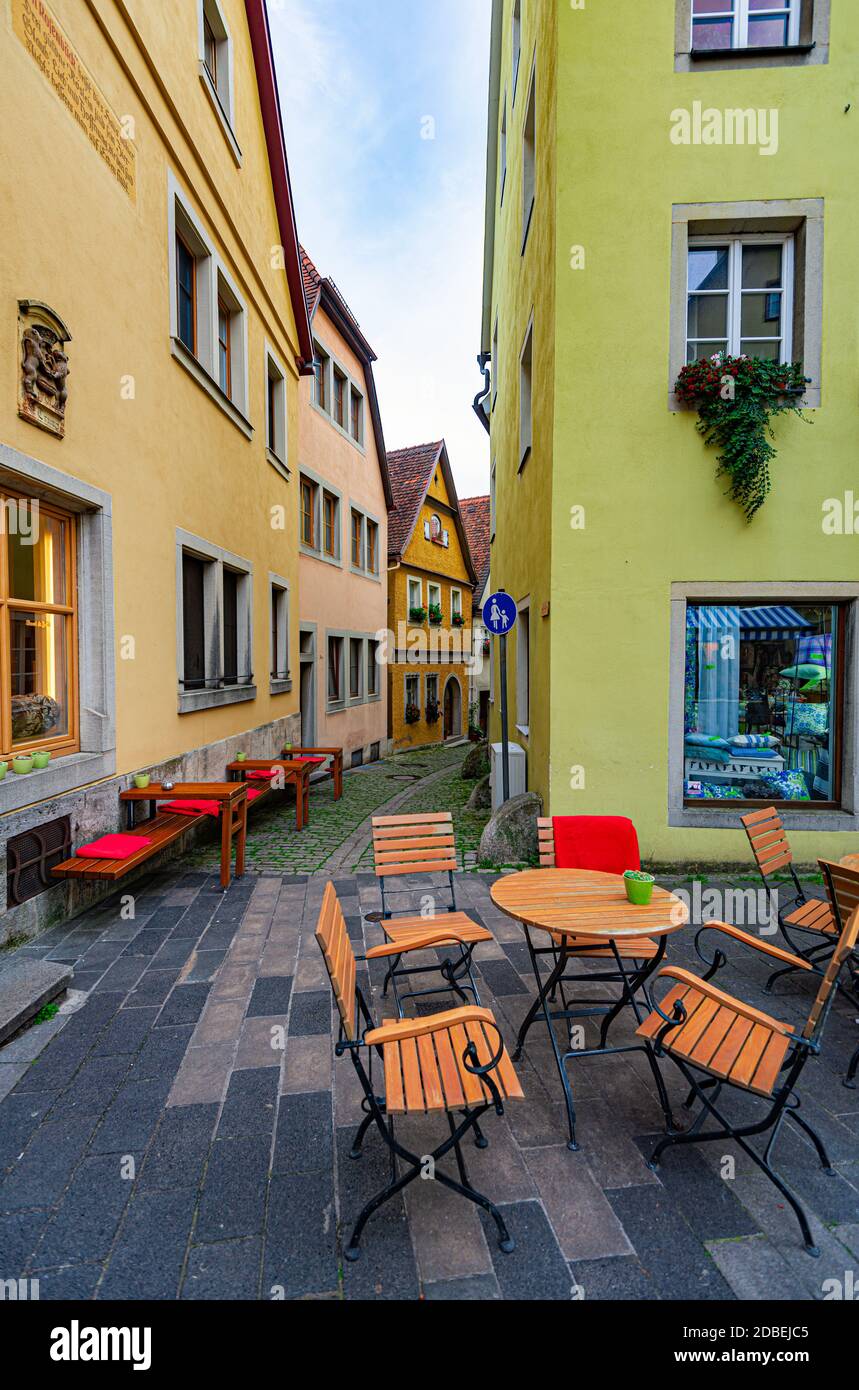 Table and chairs of street cafe in Rothenburg Ob Der Tauber, Bavaria ...