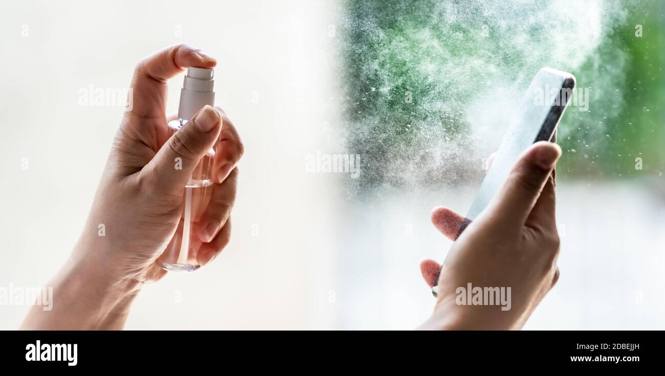 Panoramic web banner cleaning mobile phone using alocohol spray from ...