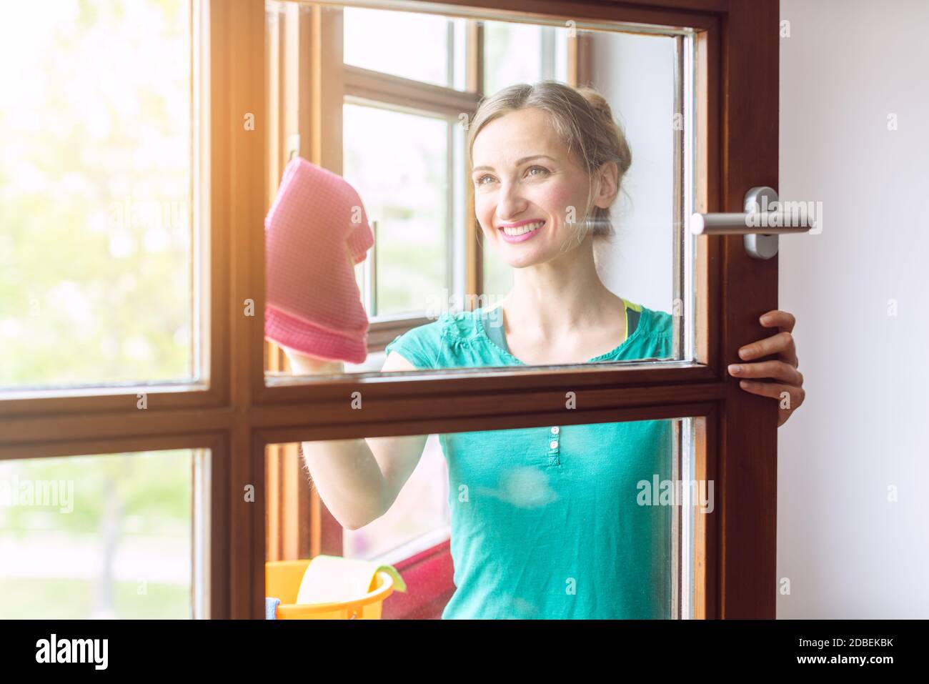 Beautiful woman cleaning the windows with cloth in spring Stock Photo ...