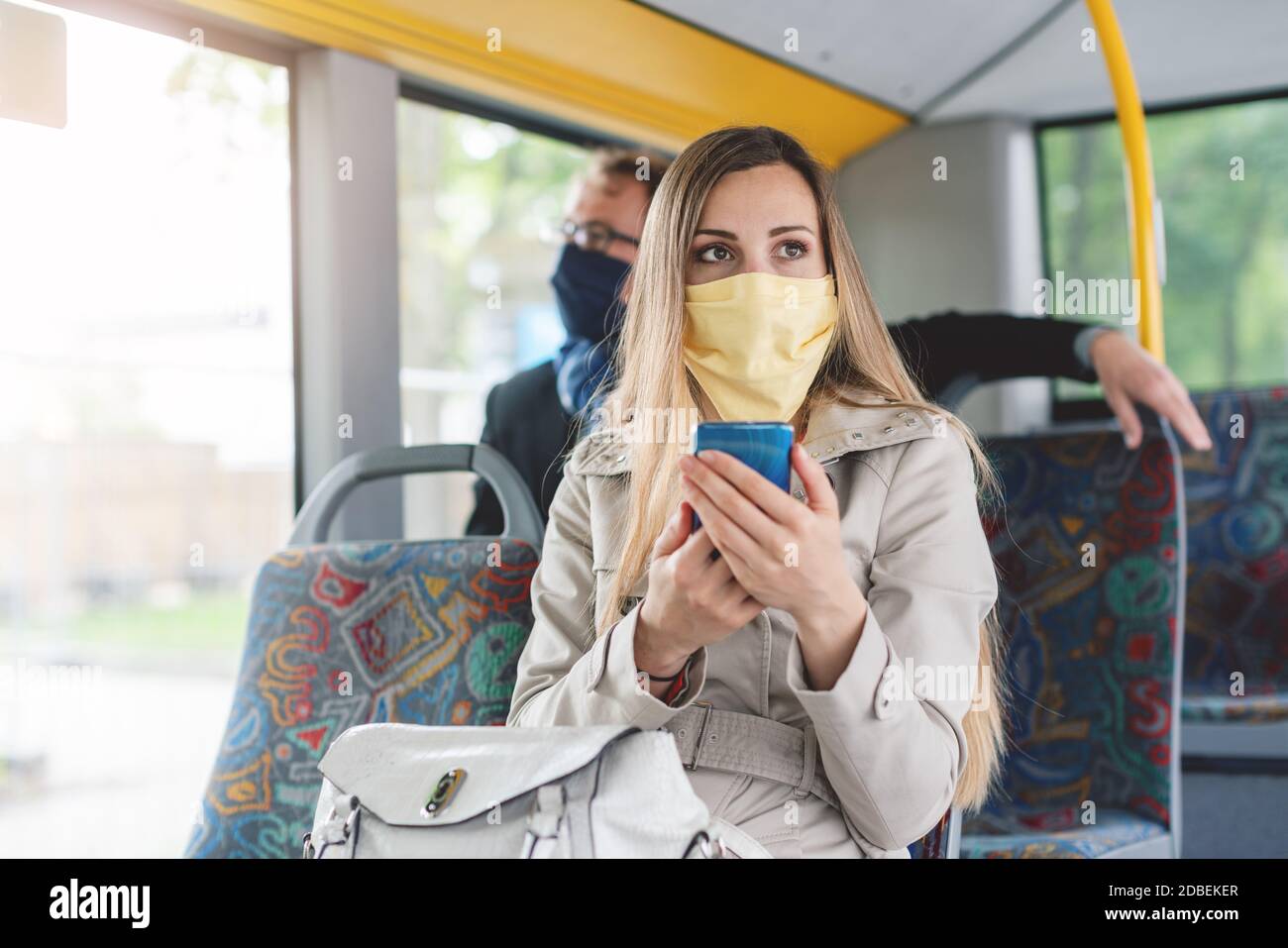 People wearing masks in the bus using public transport keeping proper ...
