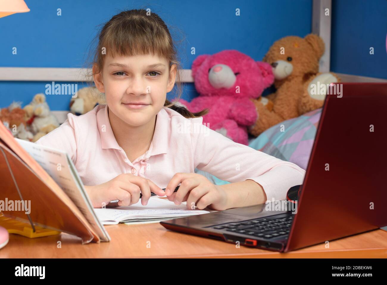 remote learning at home with a laptop and a textbook Stock Photo - Alamy