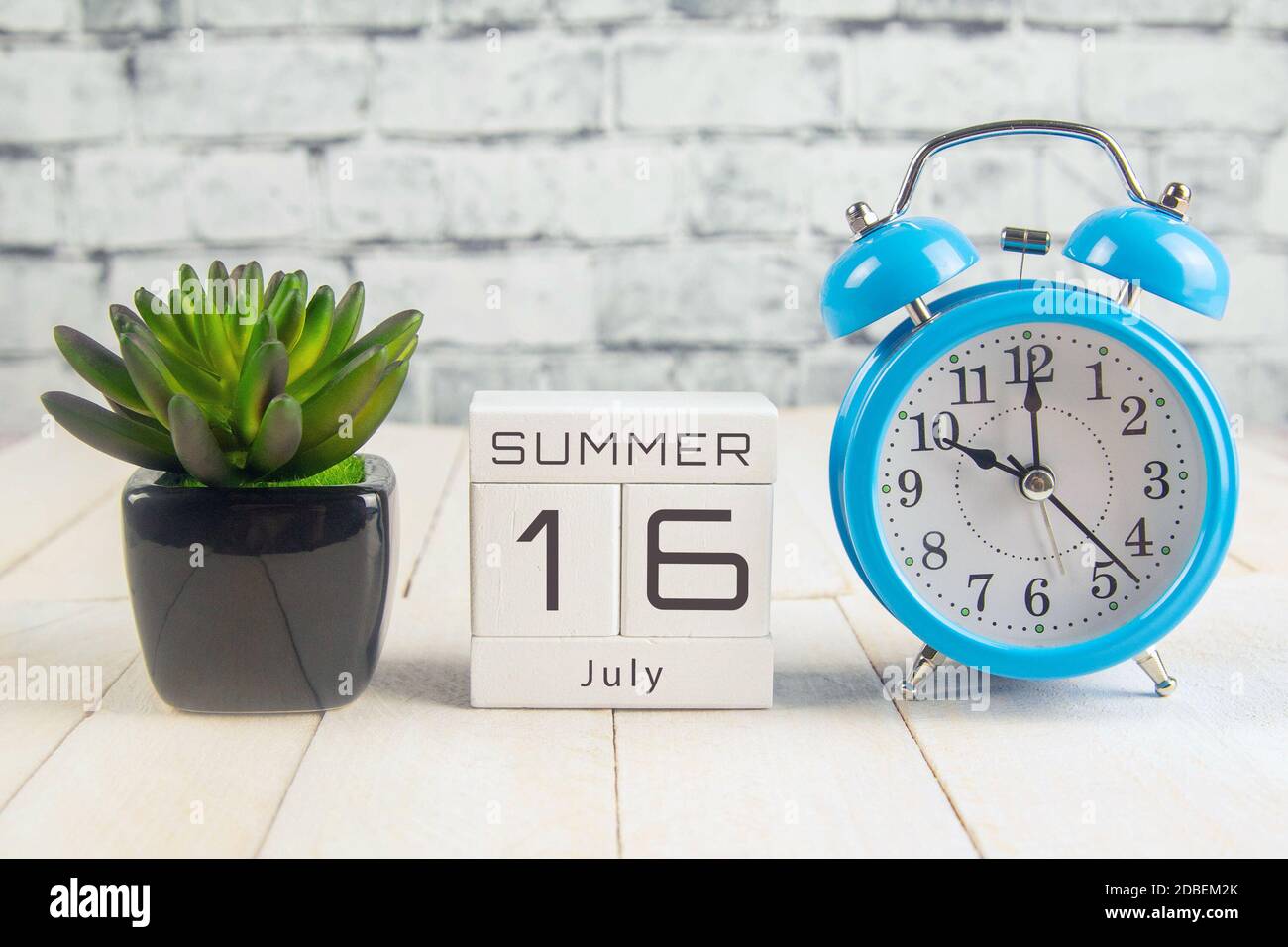 July 16 on the wooden calendar.The sixteenth day of the summer month, a ...