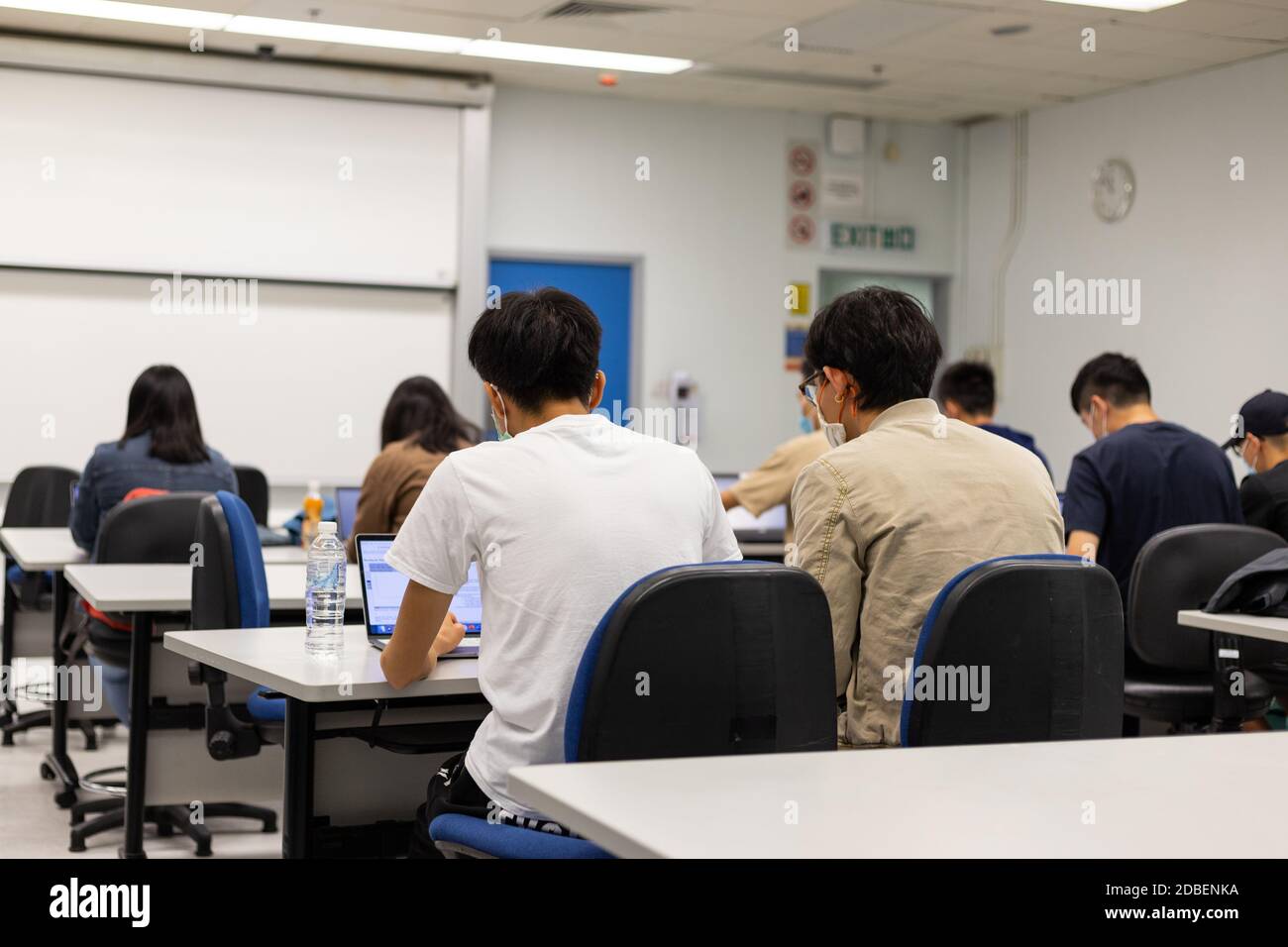 classroom with university students sitting with computers in lecture ...