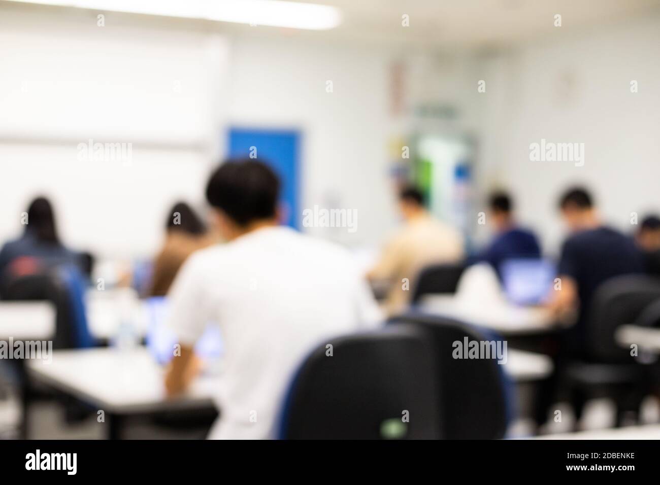 blurred classroom university students sitting with computers in lecture ...