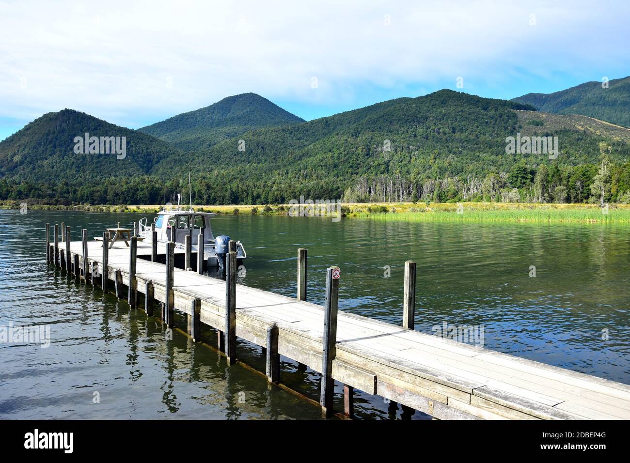 Beautiful Lake Rotoroa with the boat bridge, a boat and mountains in ...