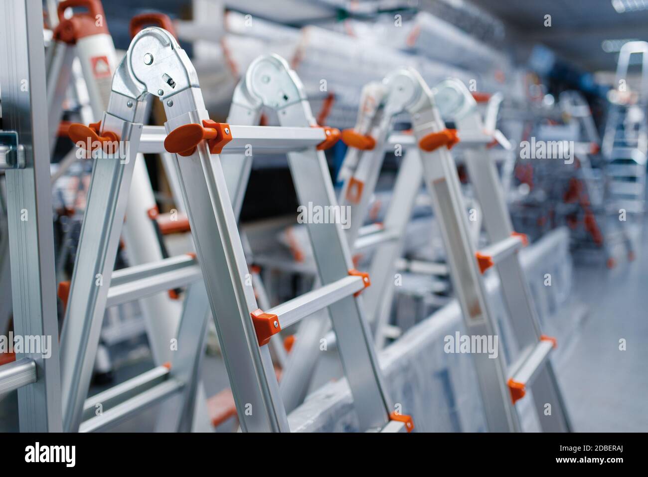 New aluminum stepladders in tool store, nobody. Showcase with ladders ...