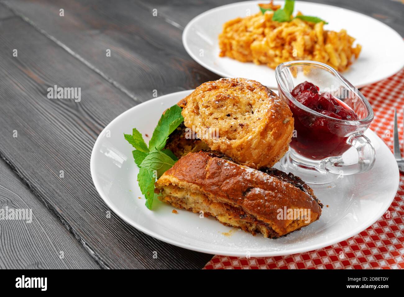 Georgian baked sweet nut roll with berry sauce Stock Photo - Alamy
