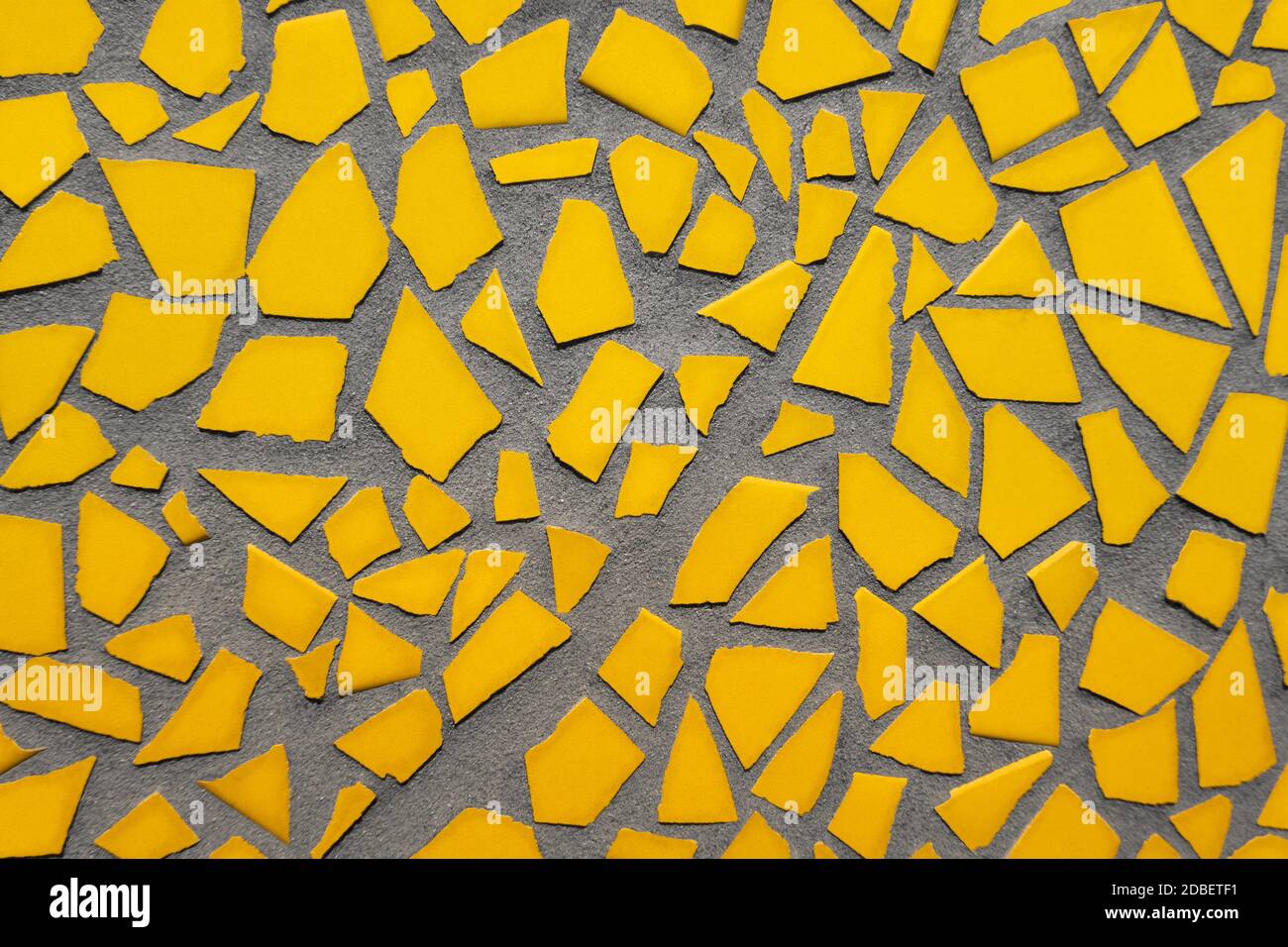 Mosaic of single yellow tile pieces on concrete Stock Photo - Alamy