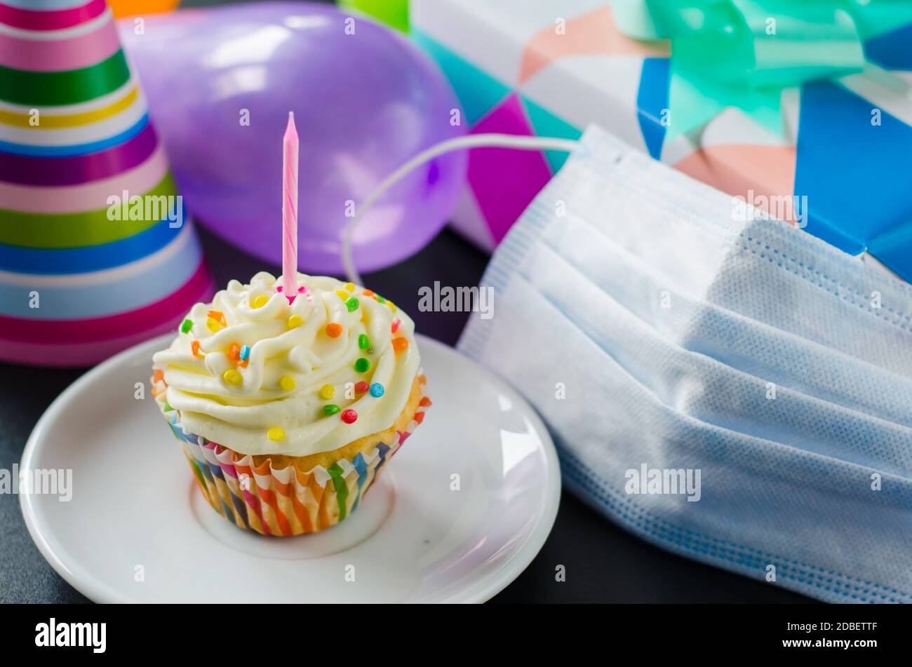 Quarantine birthday in isolation. Birthday cupcake with candle, face ...