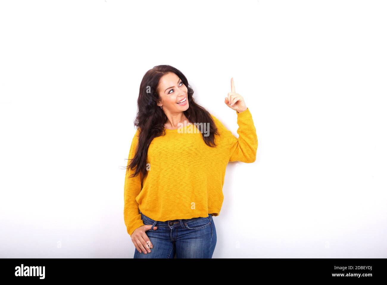Portrait of attractive older lady pointing up on white background Stock ...
