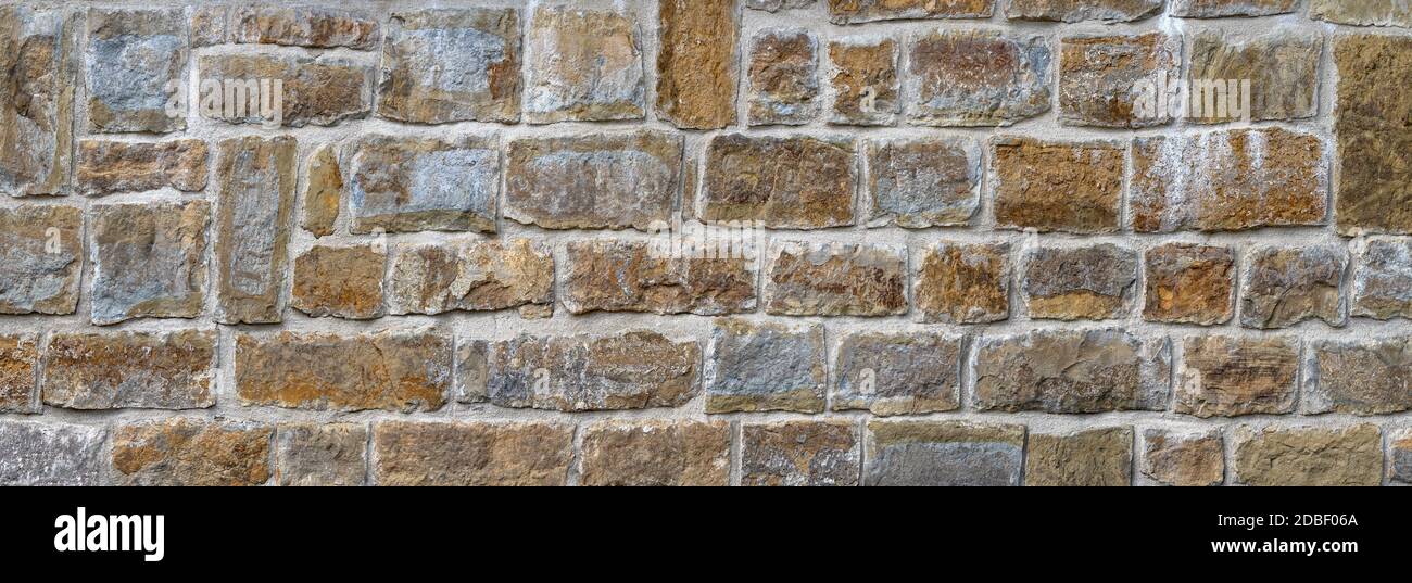 Panorama - Old stone wall made of square natural stones Stock Photo - Alamy