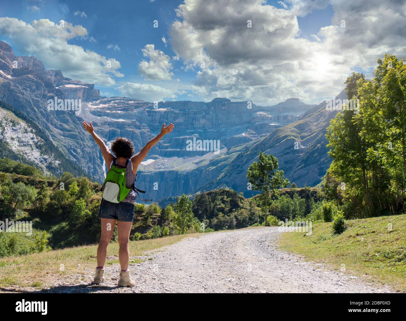 A woman hiker and cirque de Gavarnie in the French pyrenees mountains ...