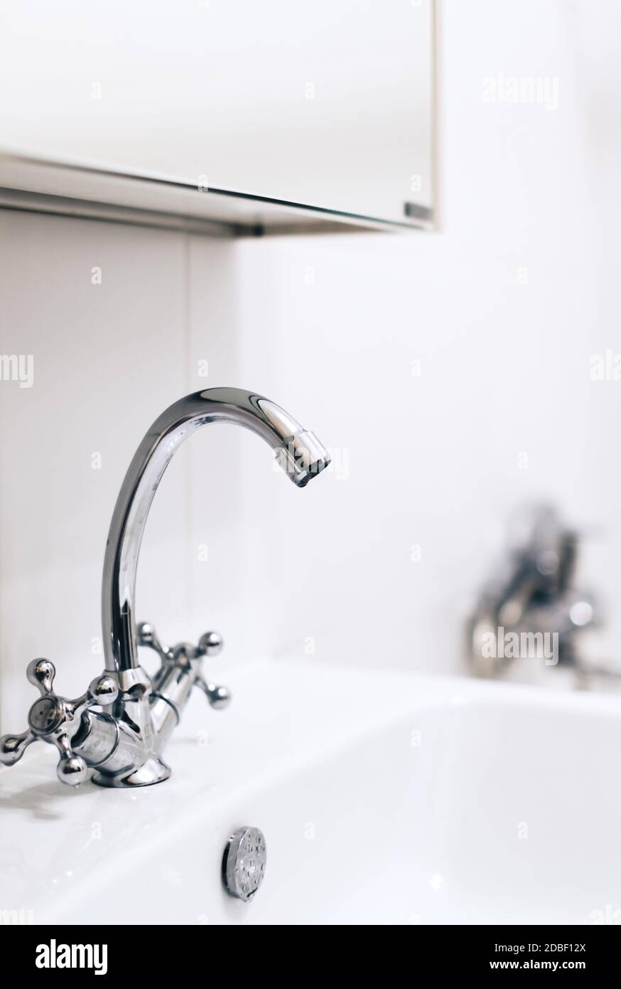 Silver faucet or water tap with metal washing sink in the bathroom ...