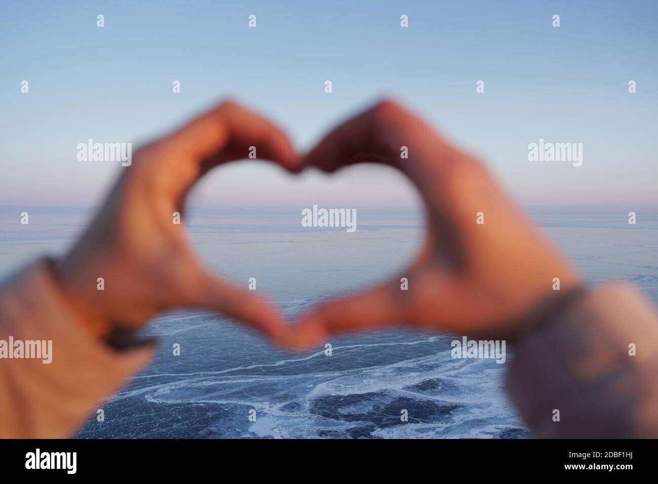 Hand shaped heart against frozen Baikal Lake Stock Photo - Alamy