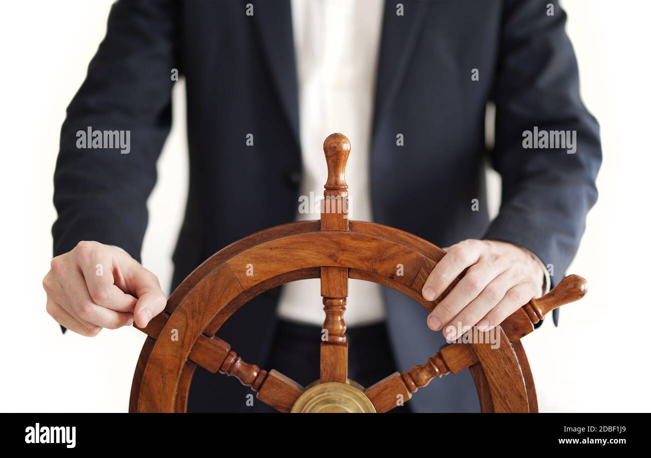 Businessman holding ship rudder Stock Photo - Alamy