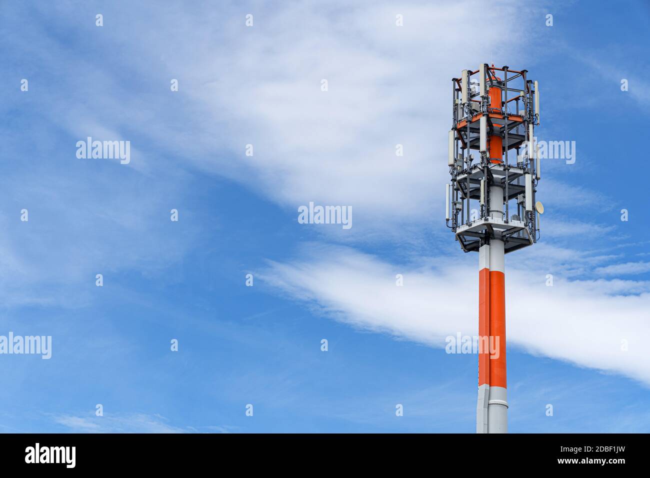 Transmission mast against the blue and white sky Stock Photo - Alamy