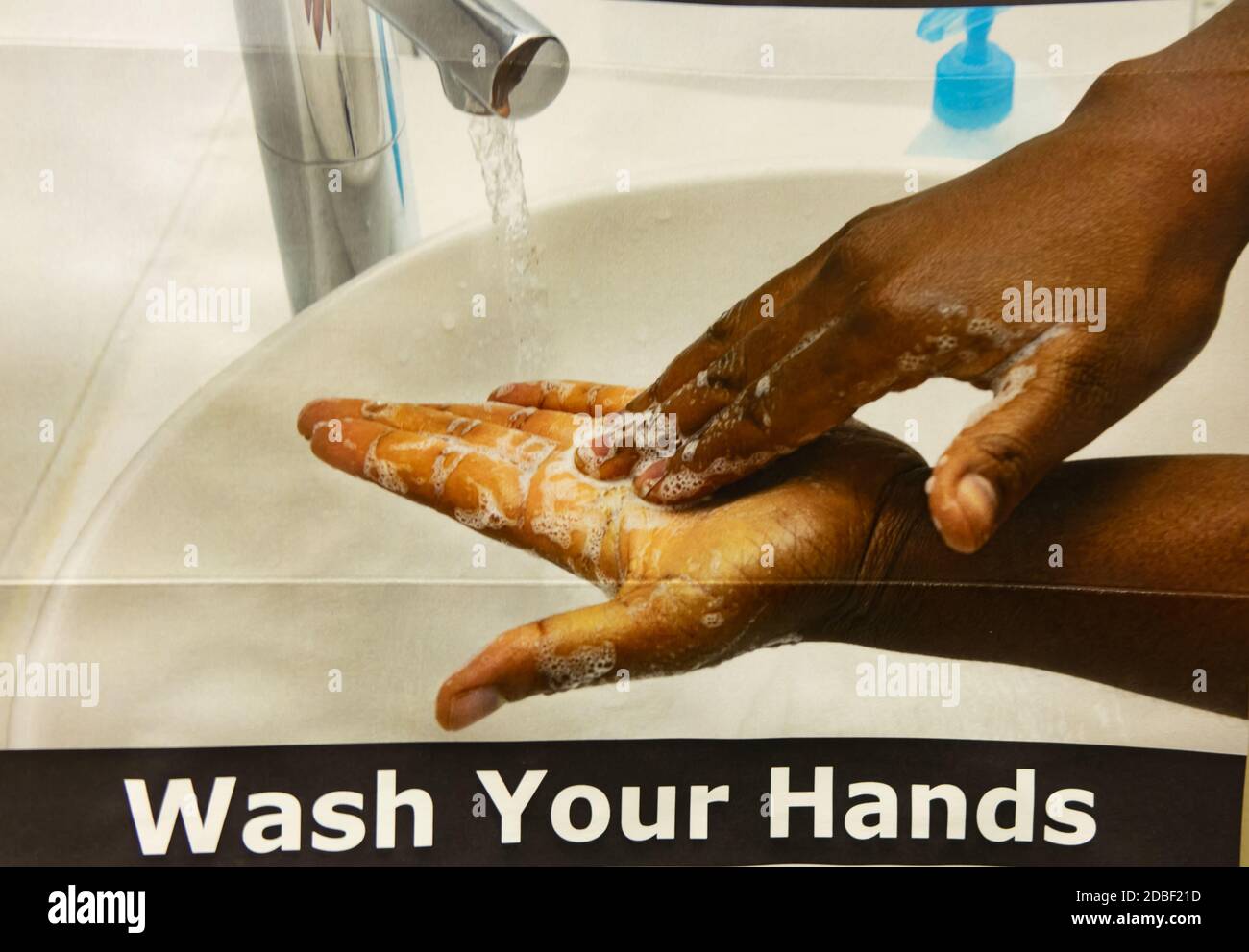 sign of an african american washing hands with soap in a sink Stock ...