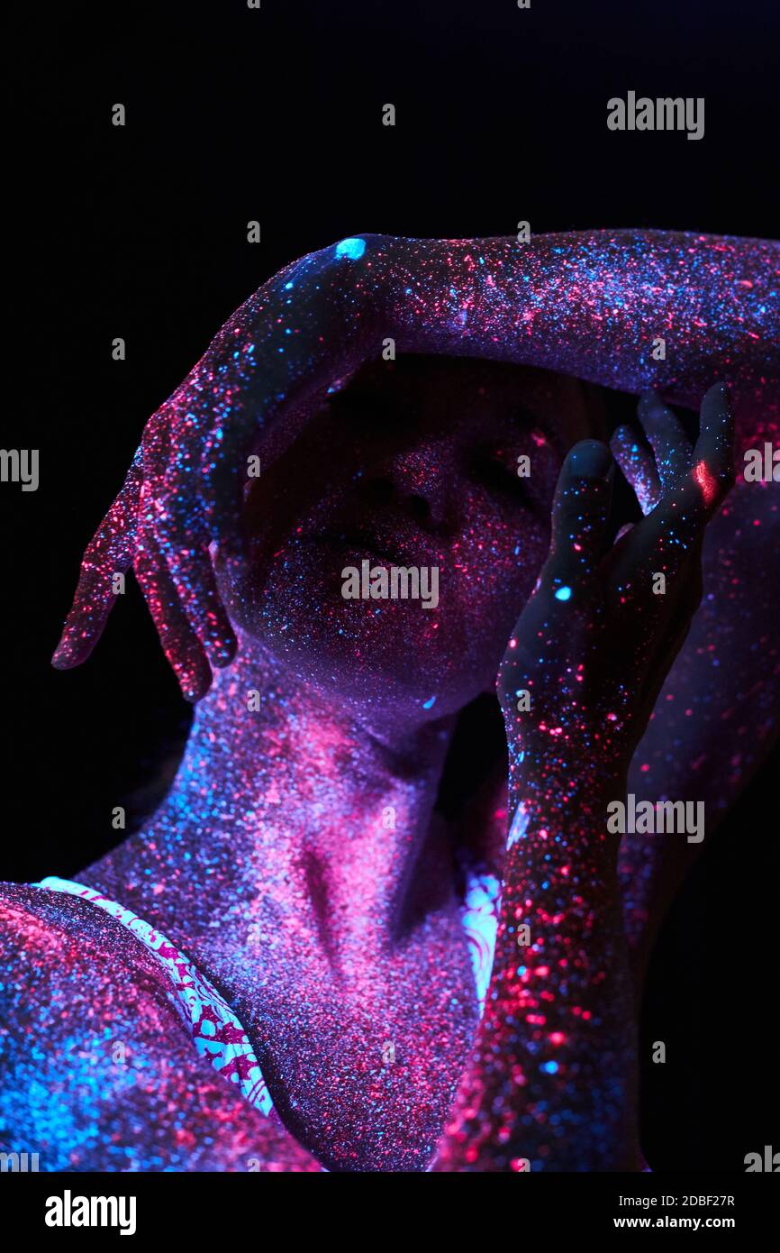 Art woman cosmos in ultraviolet light. Entire body is covered with ...