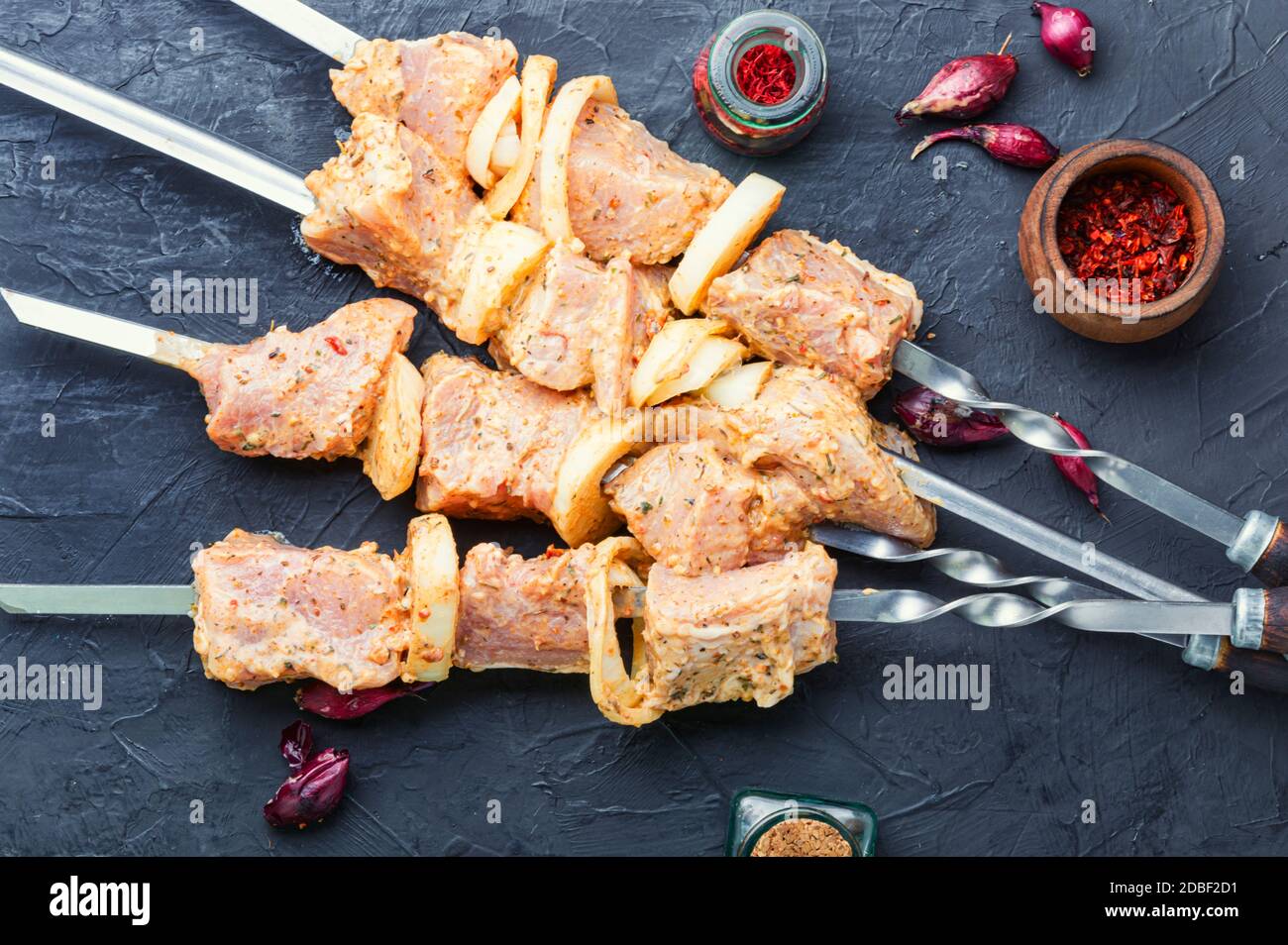 Raw meat in a barbecue marinade on skewers.Uncooked meat skewers for a ...