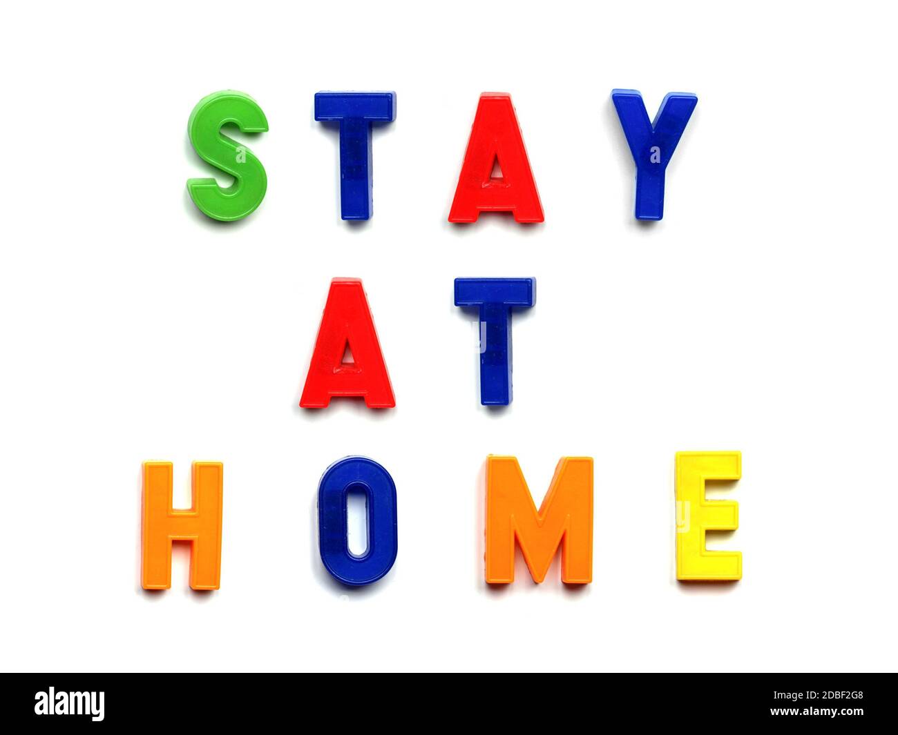 Stay at home sign written with toy magnetic letters Stock Photo - Alamy