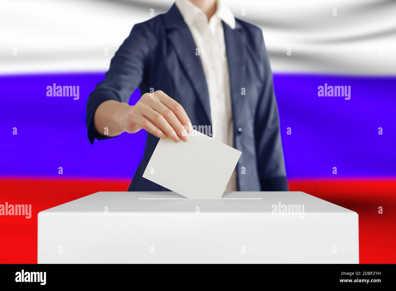Woman putting a ballot into a voting box with Russian flag on ...