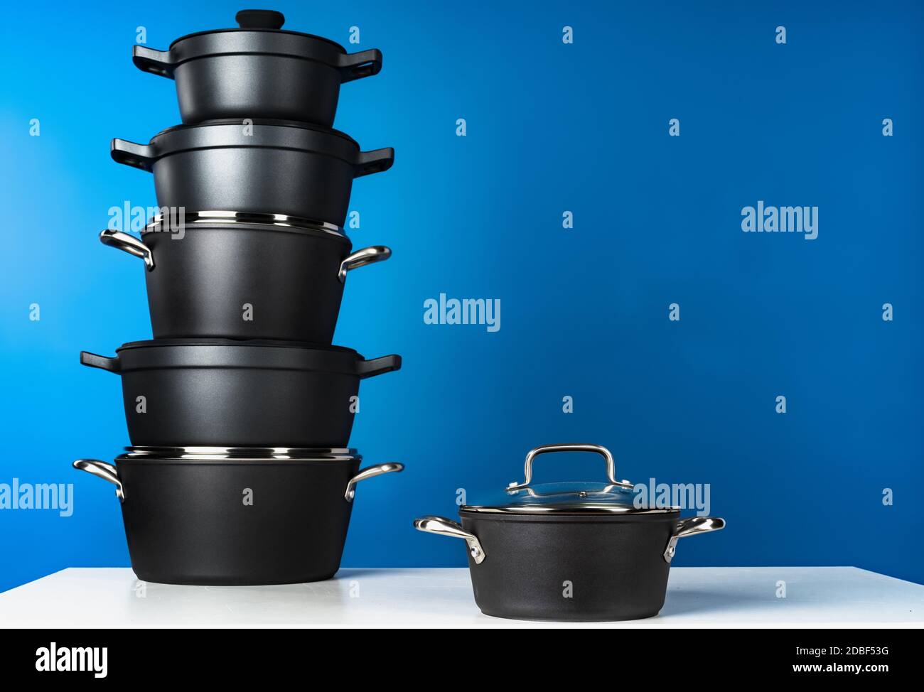 Set of black cookware against blue background Stock Photo - Alamy