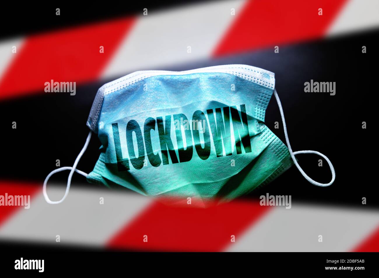 Face mask behind barrier tape, corona lockdown Stock Photo - Alamy