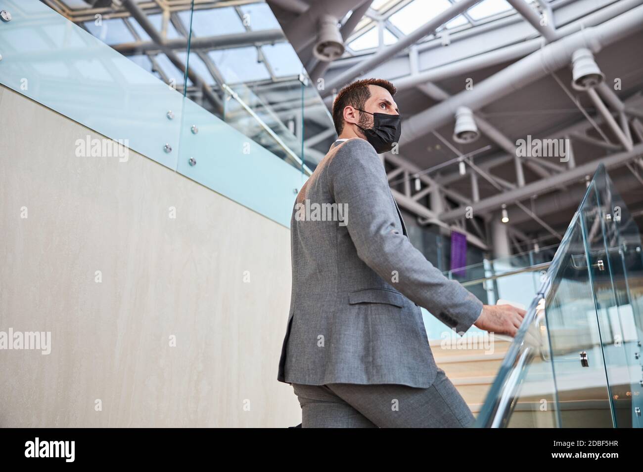 Businessman putting his hand with smartphone on handrails Stock Photo ...