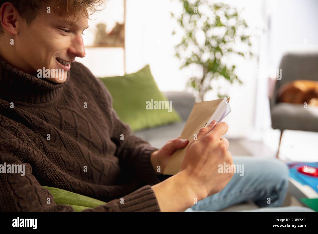 Comfortable. Man opening, recieving greeting card for New Year and ...