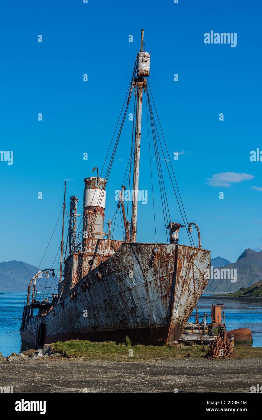 Old rusting whaler moored beneath blue sky Stock Photo - Alamy