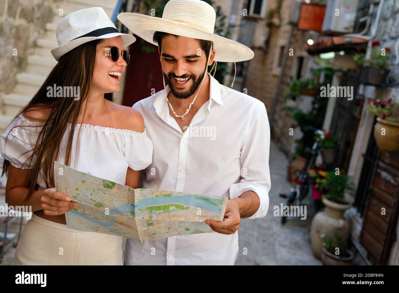 Happy tourists couple in love sightseeing city with map during summer ...