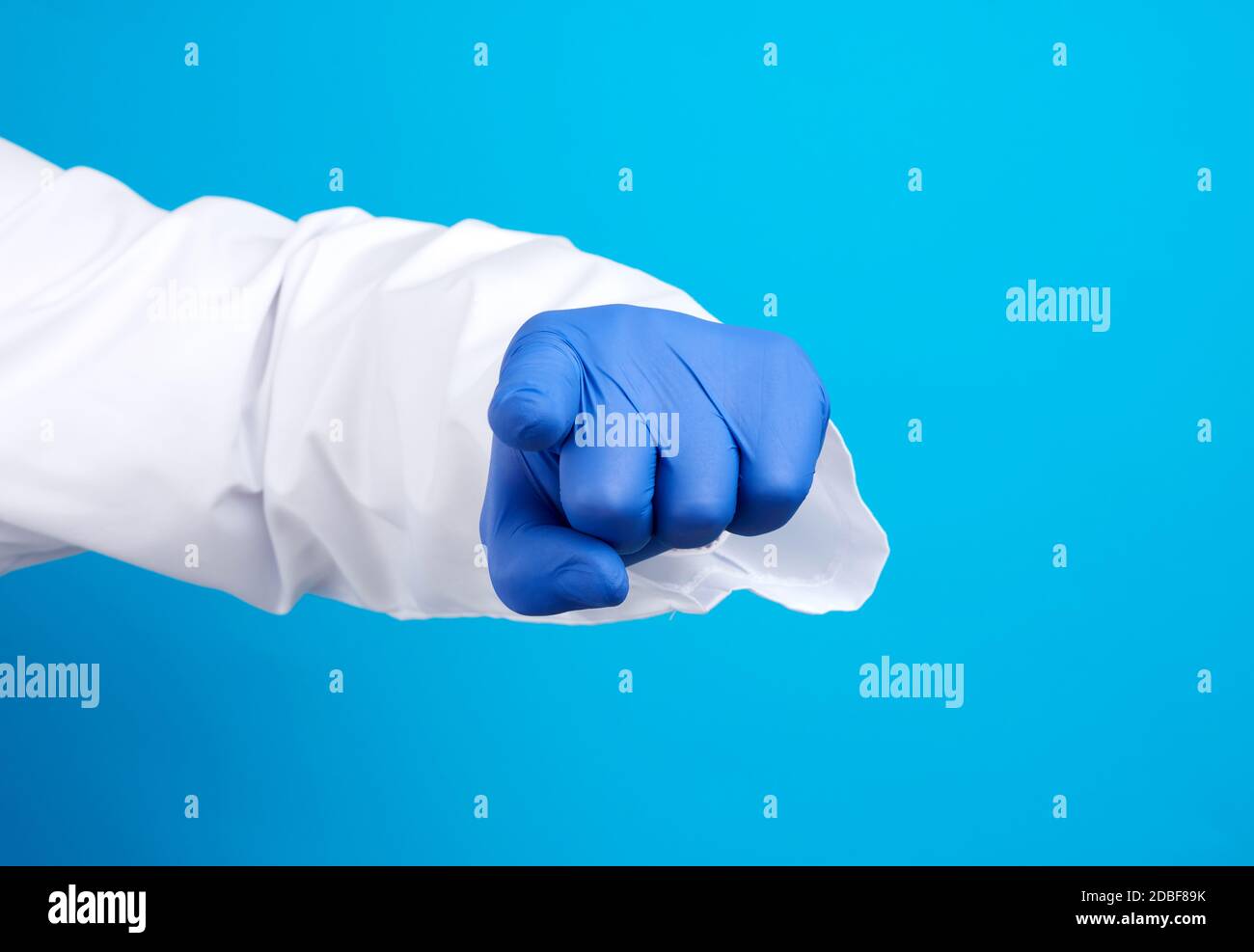 doctor's hand in blue latex glove and white coat, forefinger stretches ...