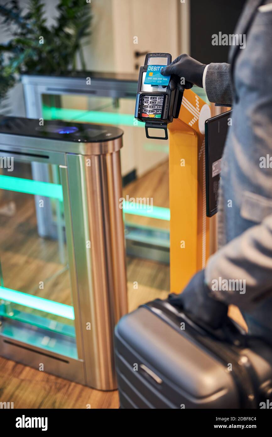 Businessman using his card on a gate scanning machine Stock Photo - Alamy