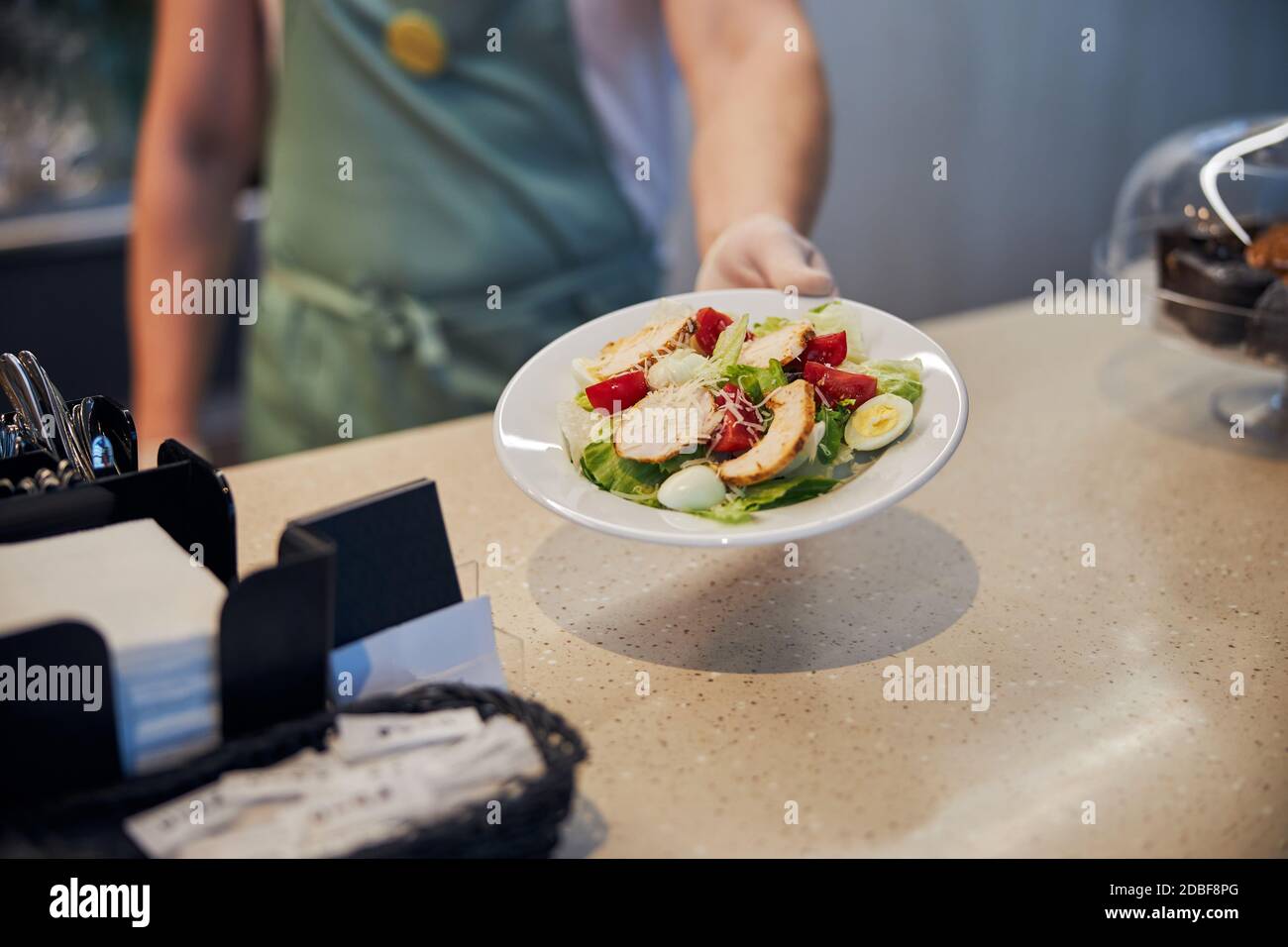 Hand passing plate hi-res stock photography and images - Alamy