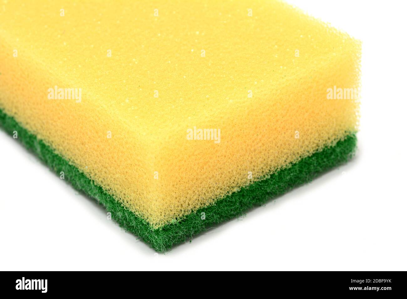 Yellow washing kitchen sponge with abrasive green scourer over white ...