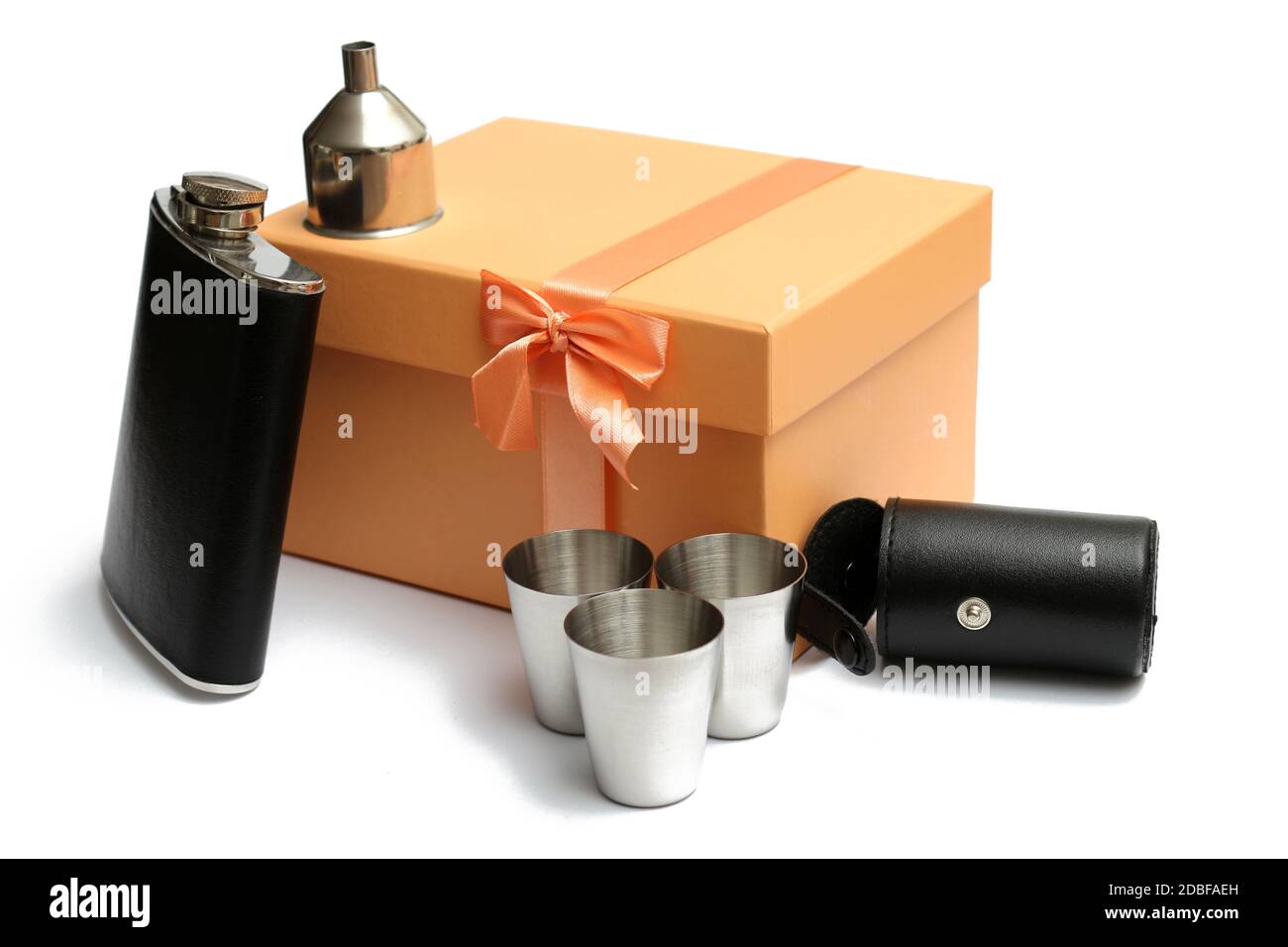 small leather hip flask with three metal mugs at orange giftbox Stock ...